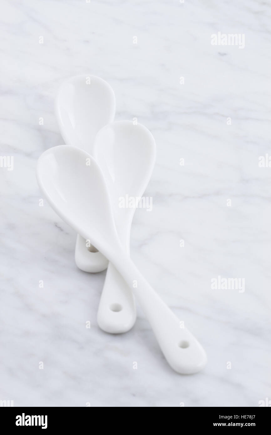 white spoon set styled on antique carrara marble Stock Photo - Alamy