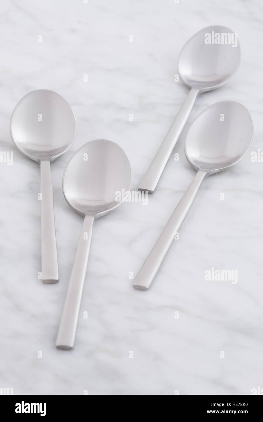 silver spoon set styled on antique carrara marble Stock Photo - Alamy
