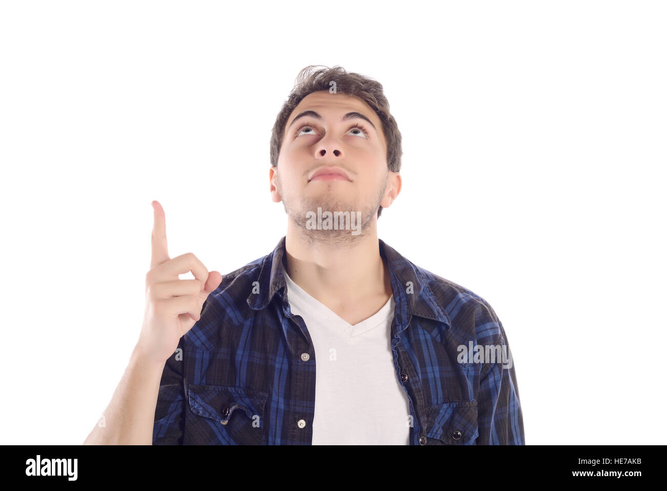 Portrait of attractive young man pointing up. Isolated white background ...