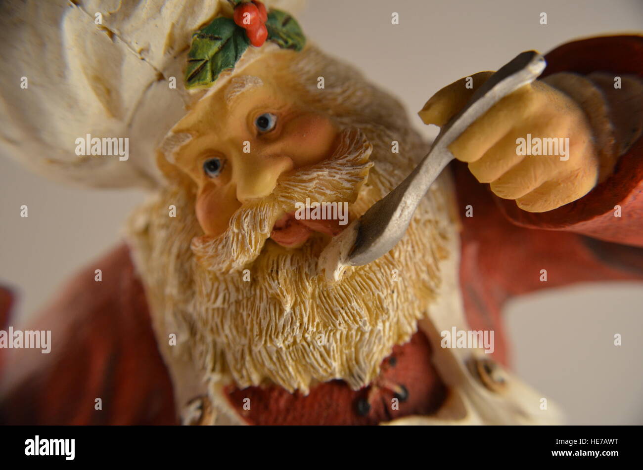 Ceramic Santa with chef's hat on licking a spoon Stock Photo - Alamy