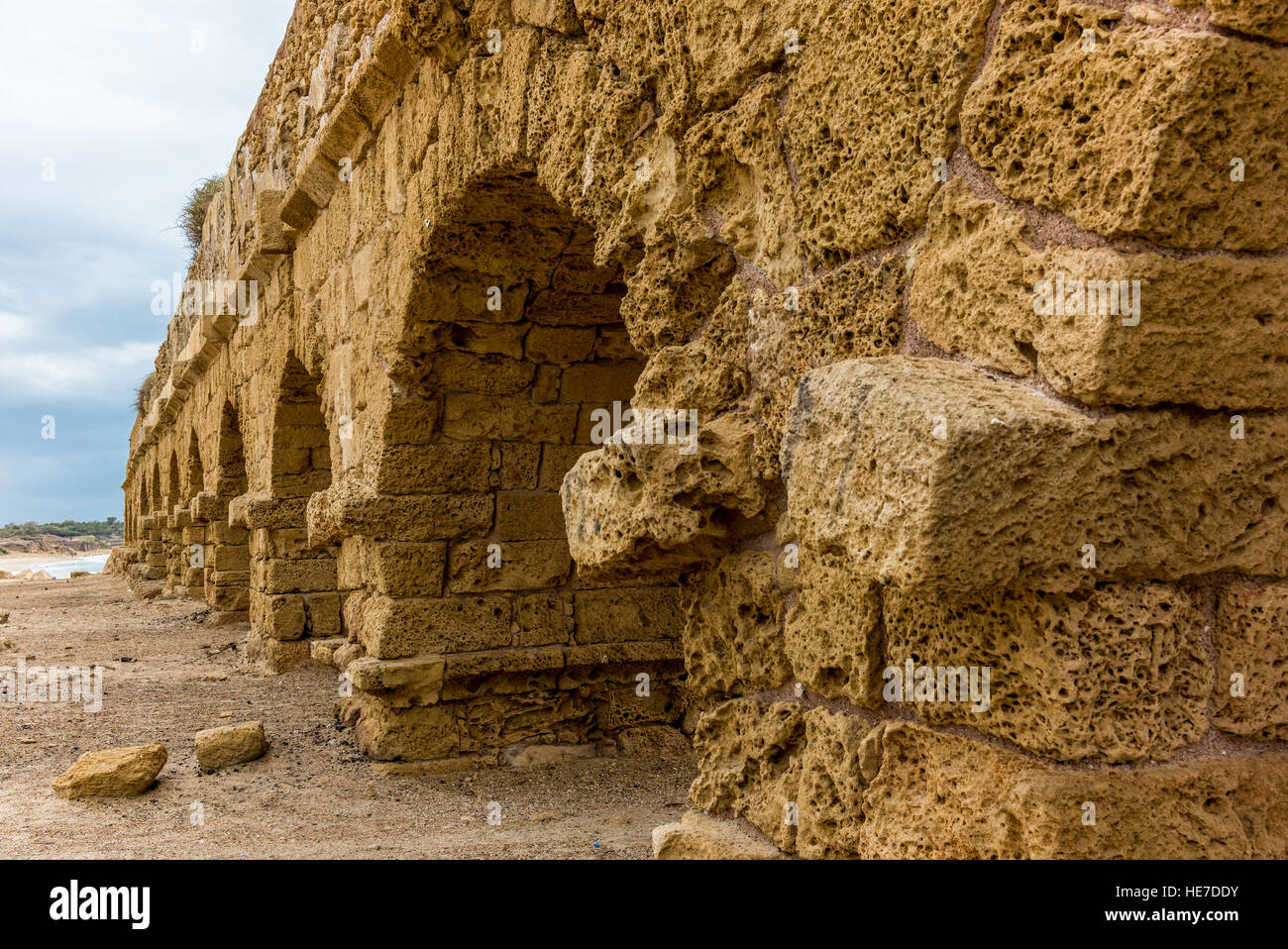 Spectacular view of the ruins of the Roman aqueduct on the beach of ...