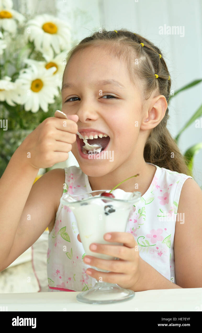 Girl eating sweet dessert with berries Stock Photo - Alamy