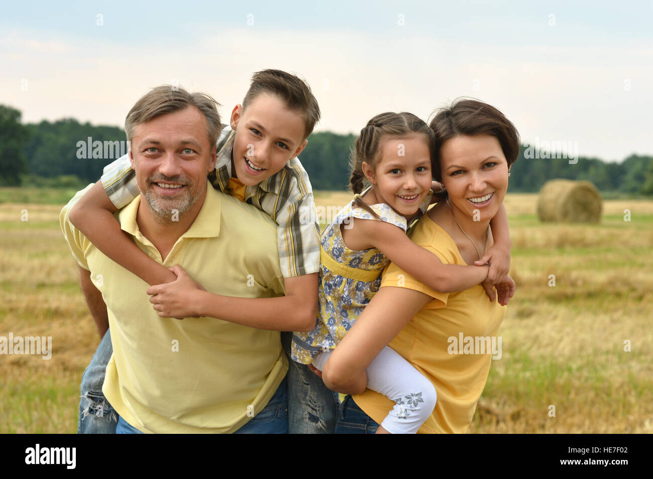 happy family at field Stock Photo - Alamy