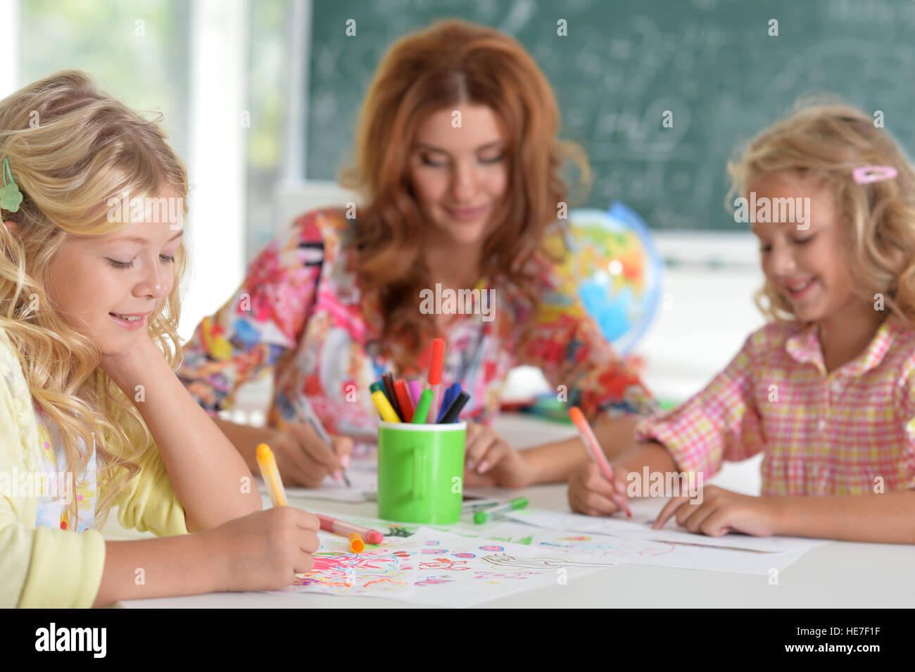 teacher with two girls Stock Photo - Alamy