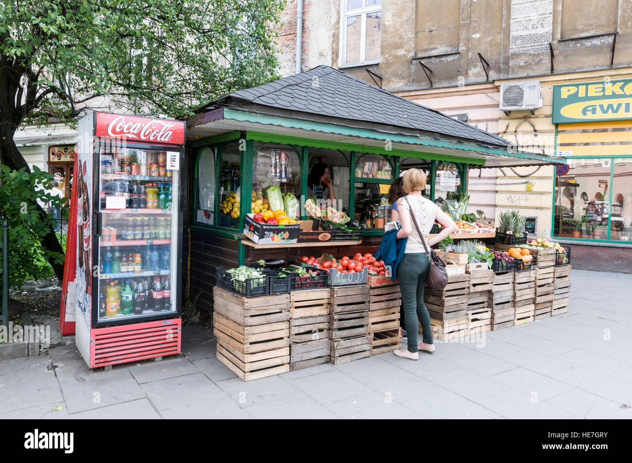 A customer buying some vegetables at one of the many kiosks (common in ...
