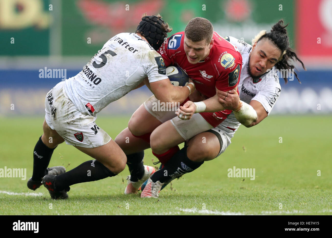 Scarlets' Scott Williams (centre) is tackled by RC Toulon's Leigh ...
