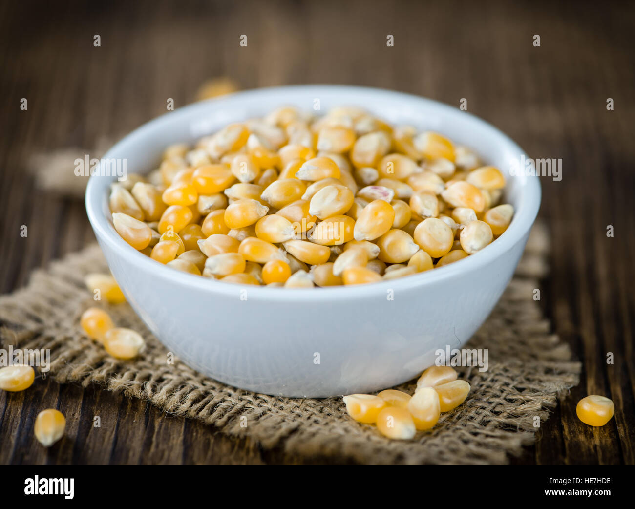 Portion of Corn (detailed close-up shot) on wooden background ...
