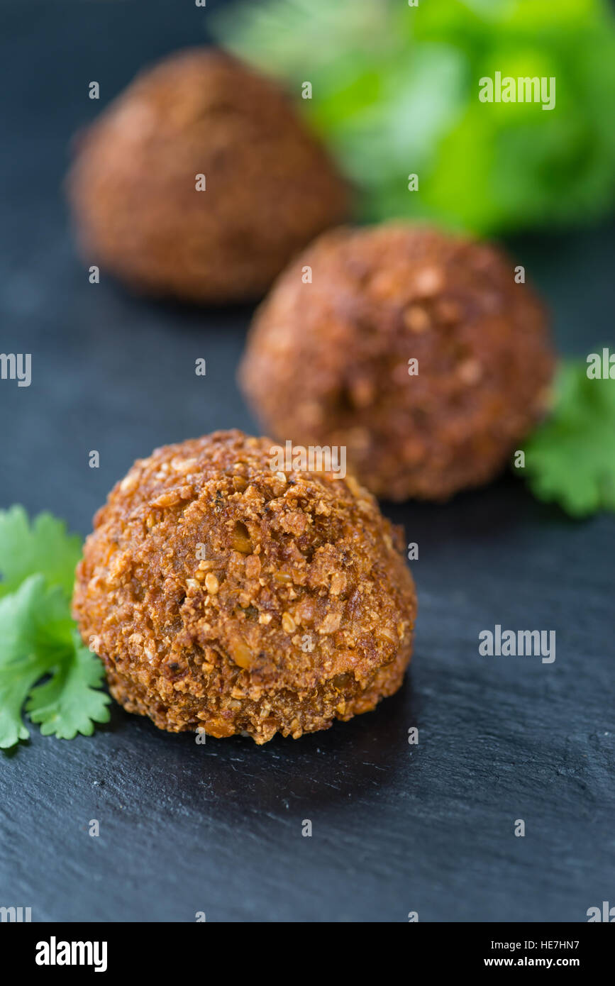 Portion of Falafel on an old wooden table (close-up shot; selective ...