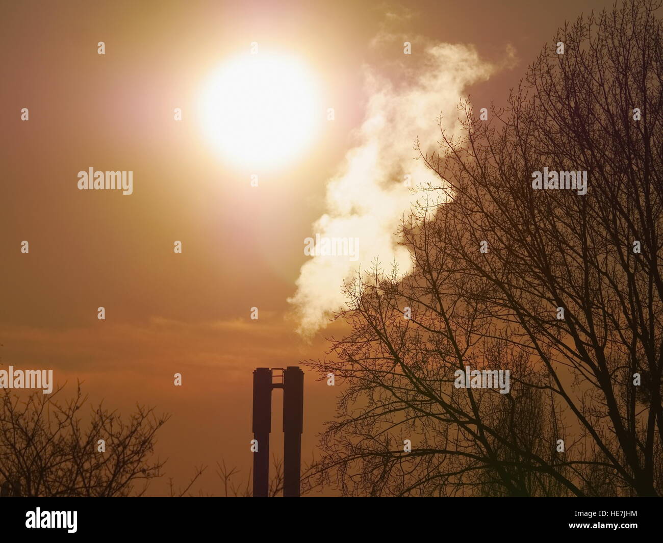 industrial chimneys sun Stock Photo - Alamy