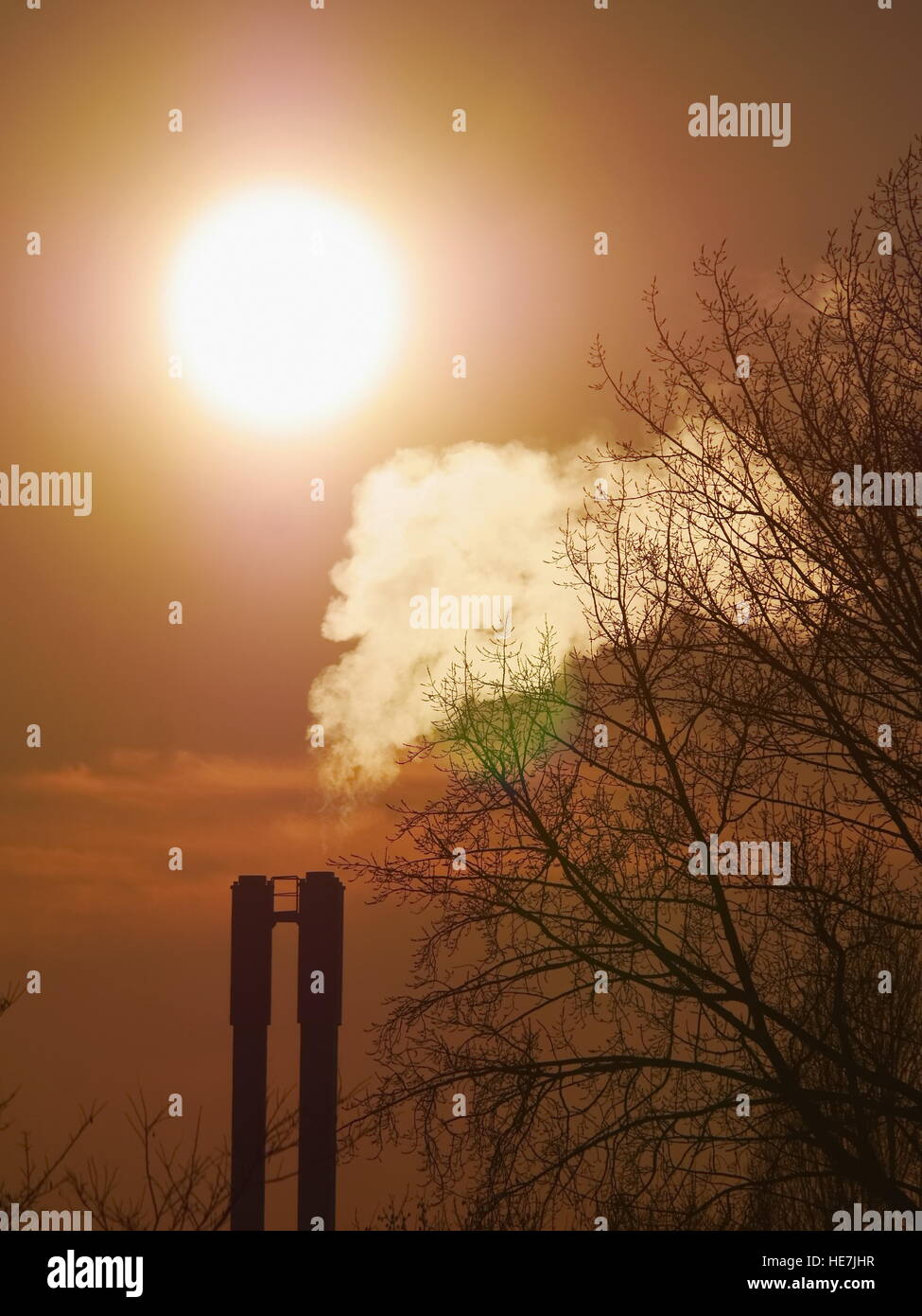 industrial chimneys sun Stock Photo - Alamy