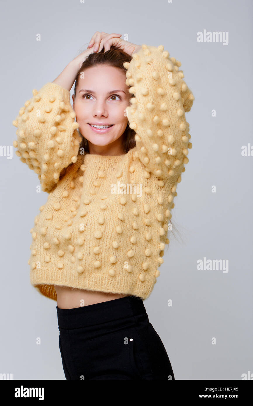 Pretty model in yellow jacket in studio on blank background Stock Photo ...