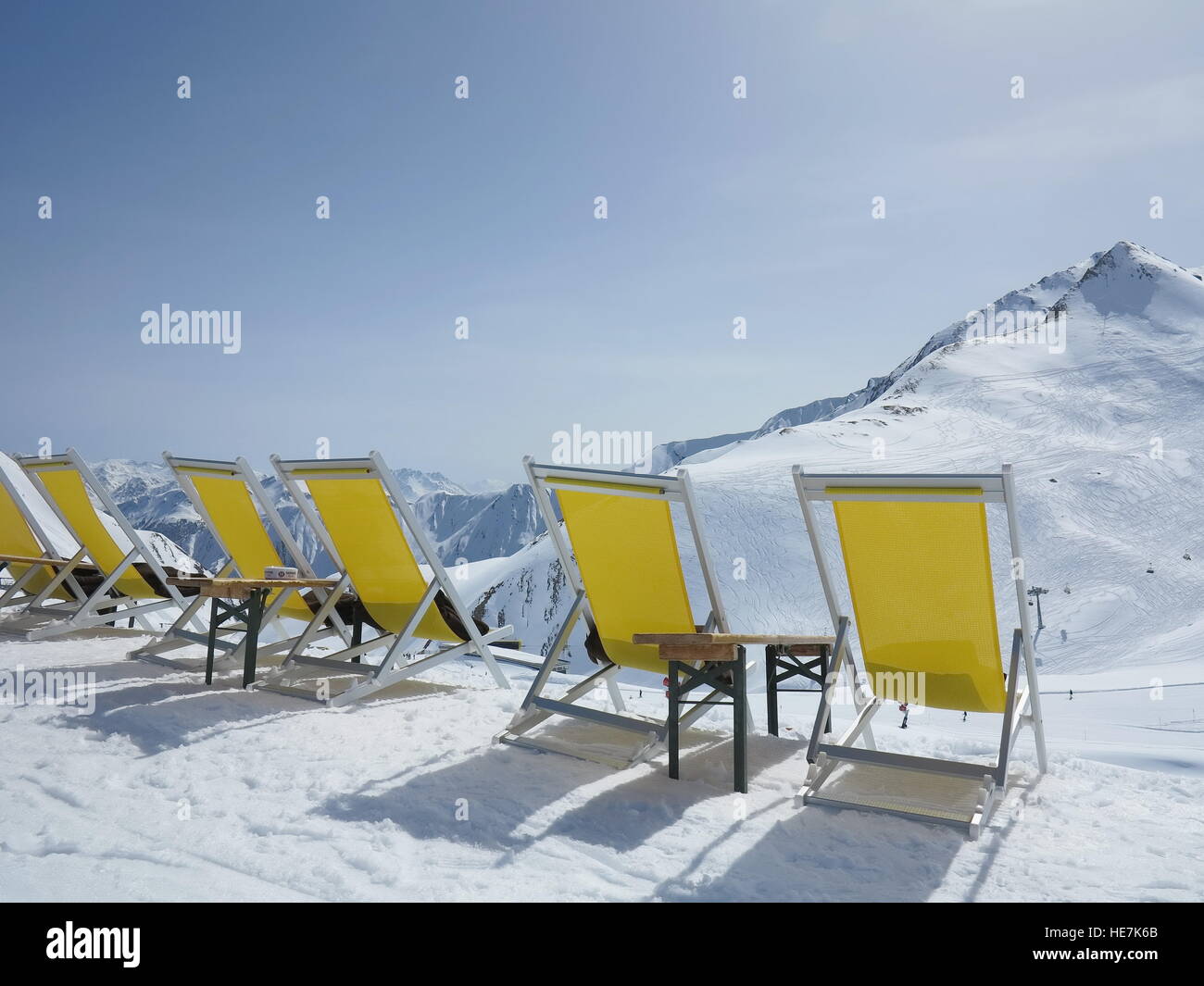 Row of deck chairs overlooking an Alpine peak Stock Photo - Alamy