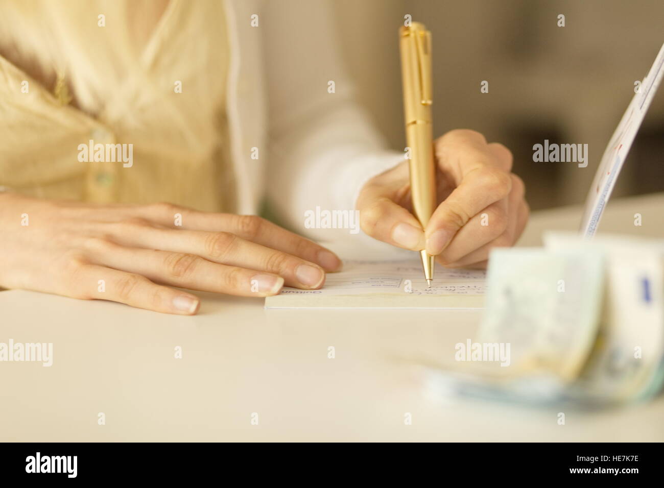 Signing a cheque Stock Photo - Alamy