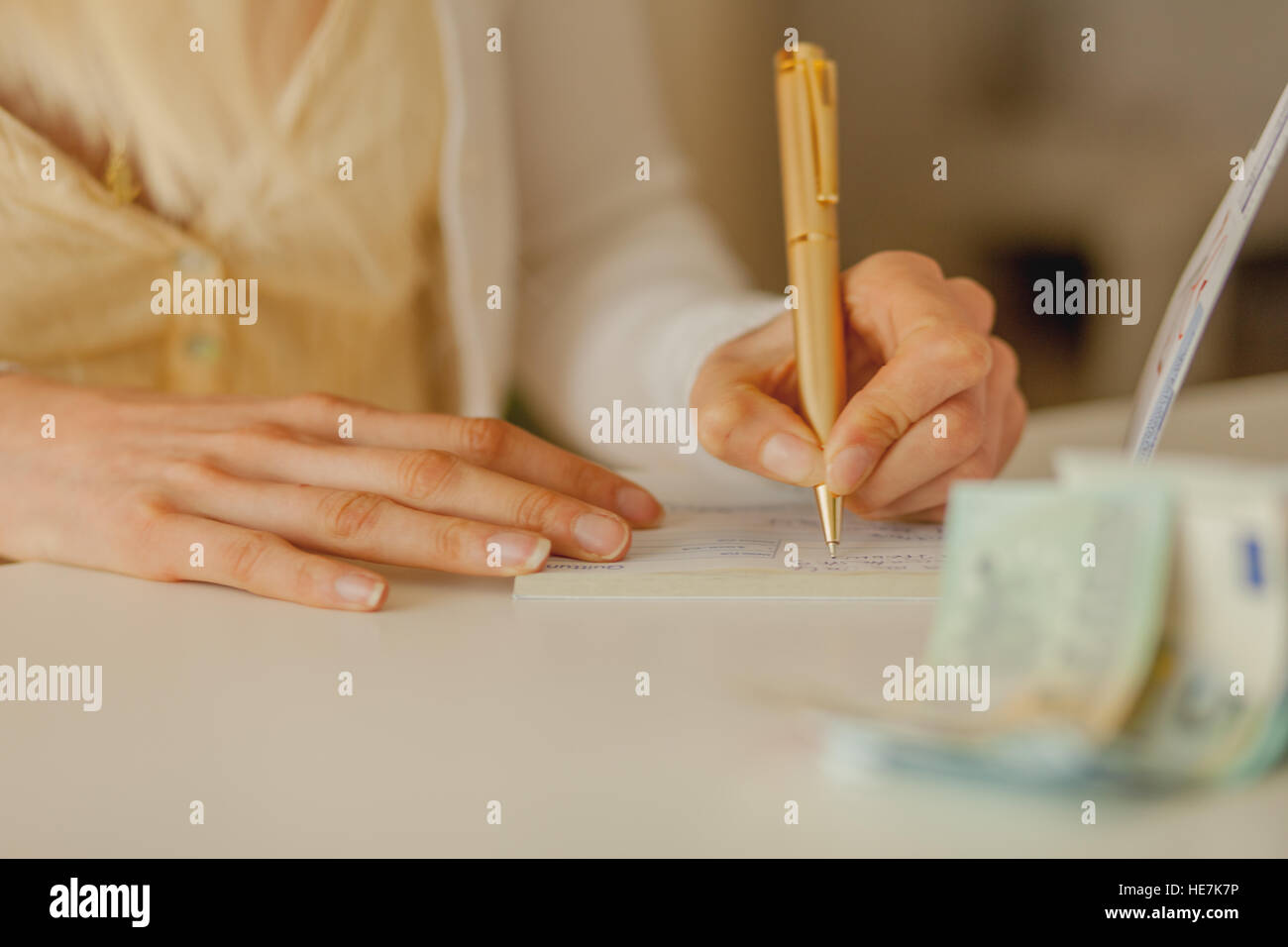 Signing a cheque Stock Photo - Alamy