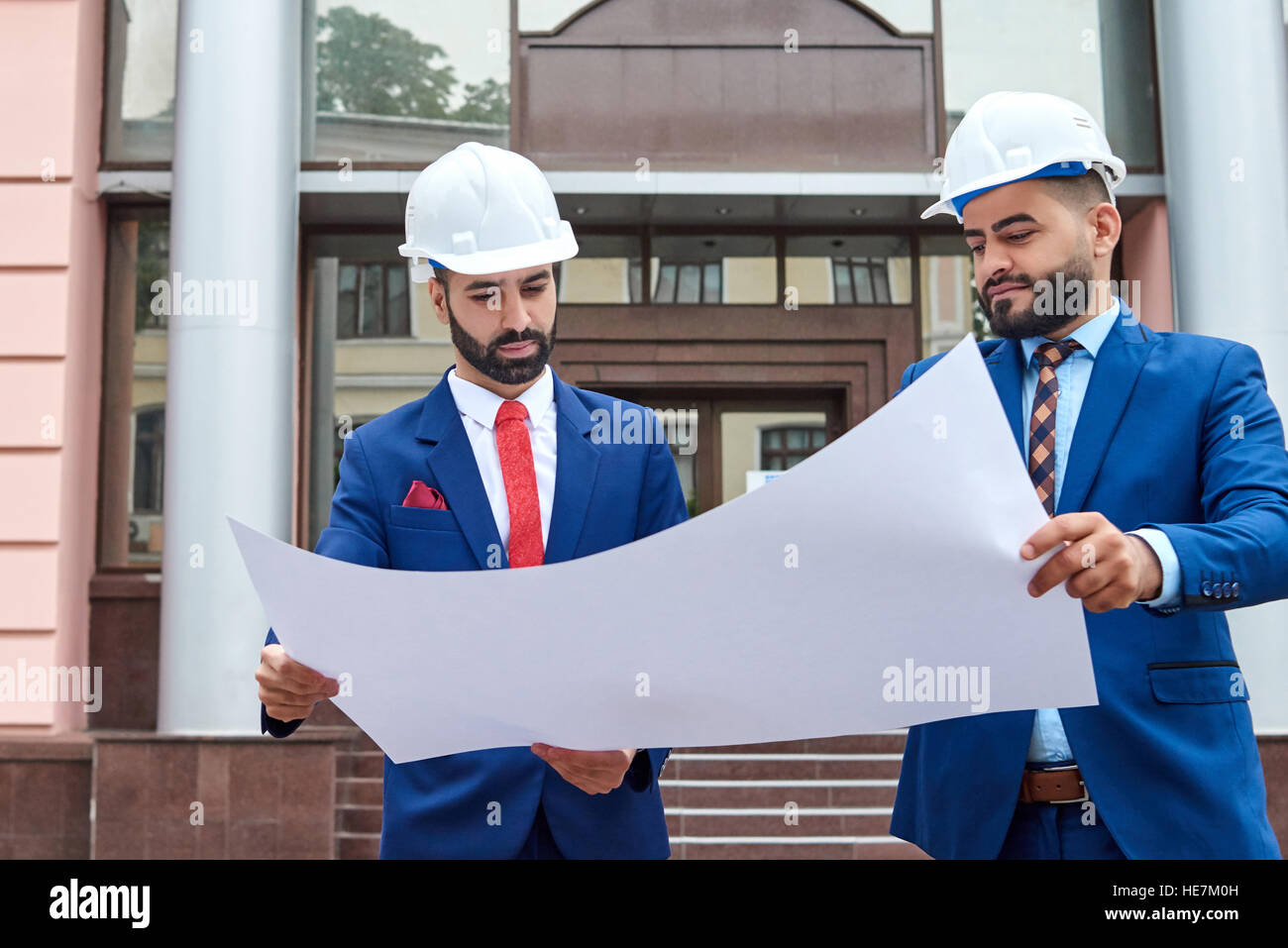 Turning project into a reality. Shot of two male architects holding a ...