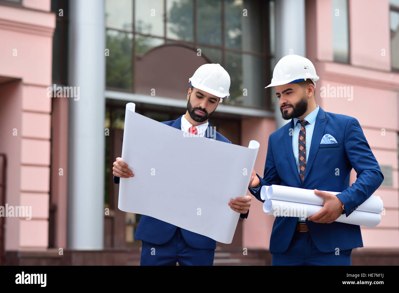 Accurate professionals. Shot of two male architects in hardhats ...