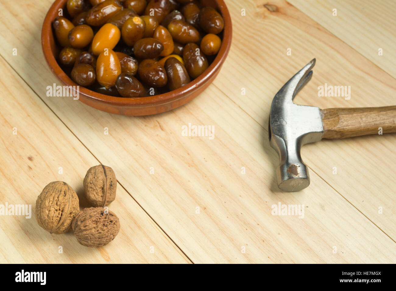 Dice and nuts on a background of pine wood. Artificial lighting with ...