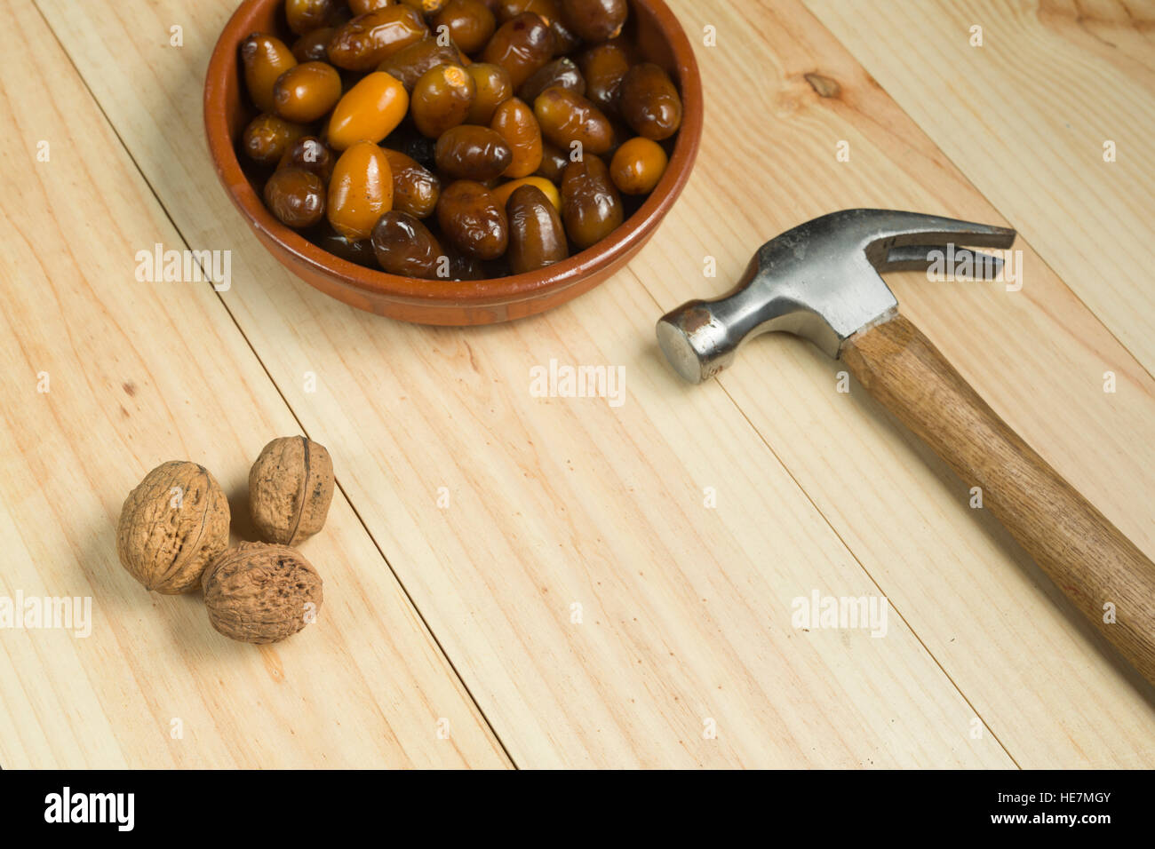 Dice and nuts on a background of pine wood. Artificial lighting with ...