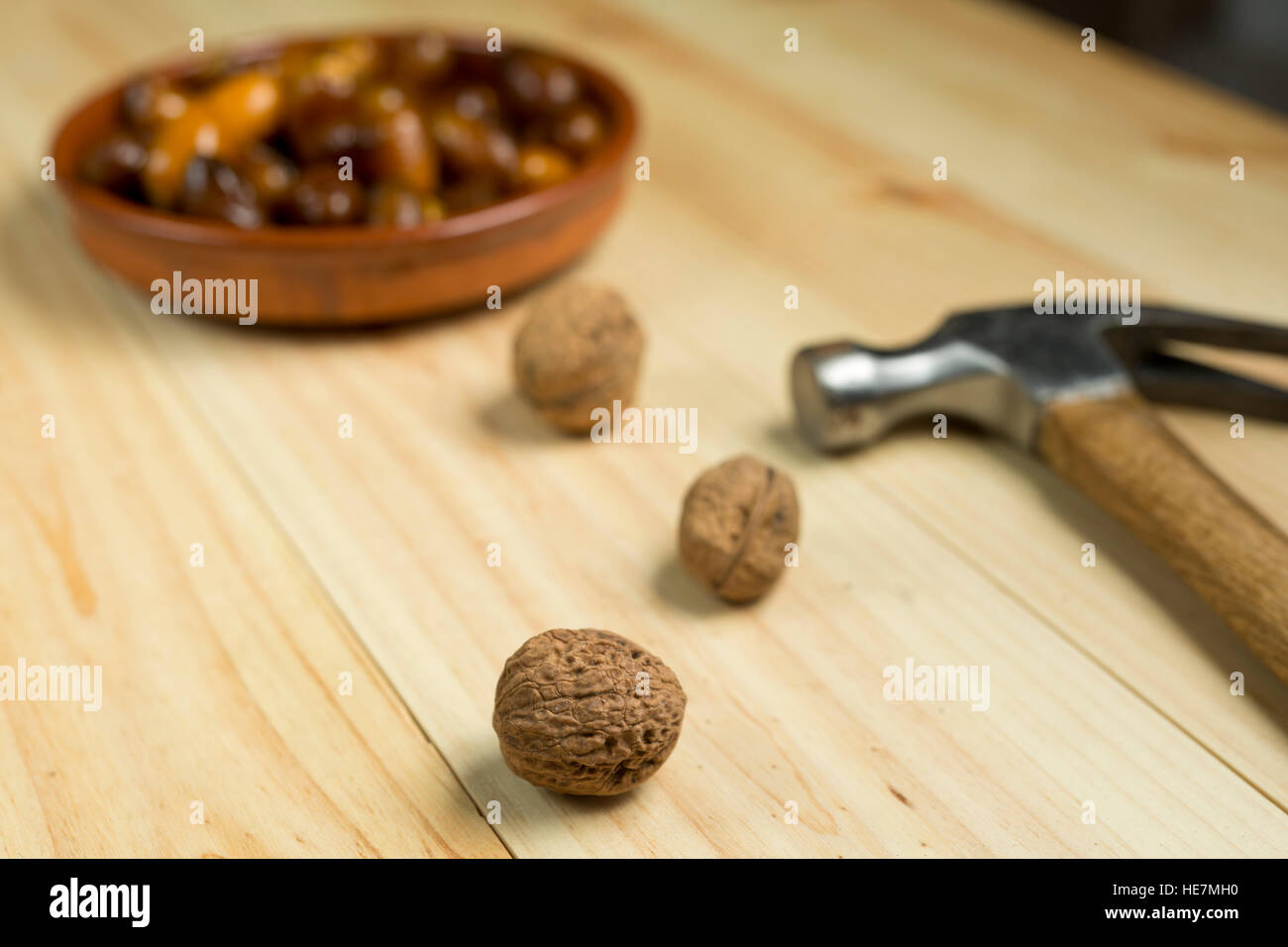 Dice and nuts on a background of pine wood. Artificial lighting with ...