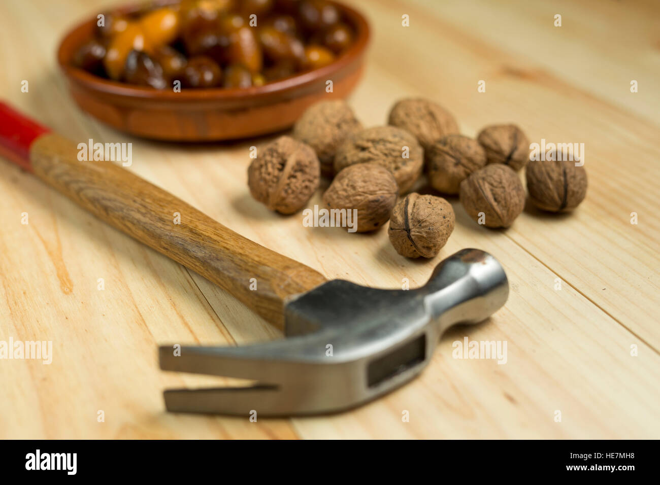 Dice and nuts on a background of pine wood. Artificial lighting with ...