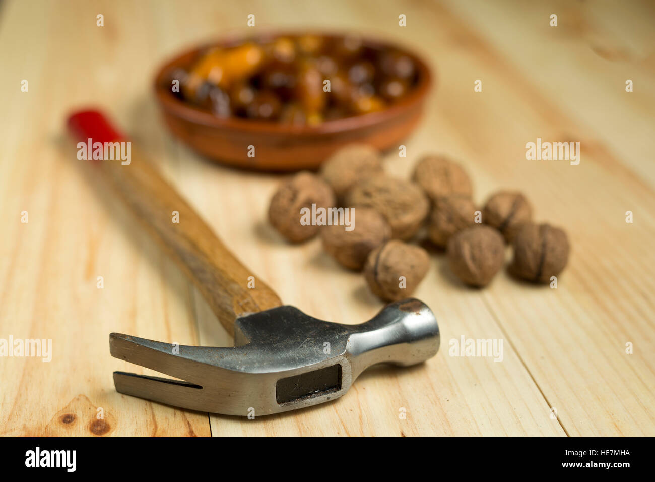 Dice and nuts on a background of pine wood. Artificial lighting with ...