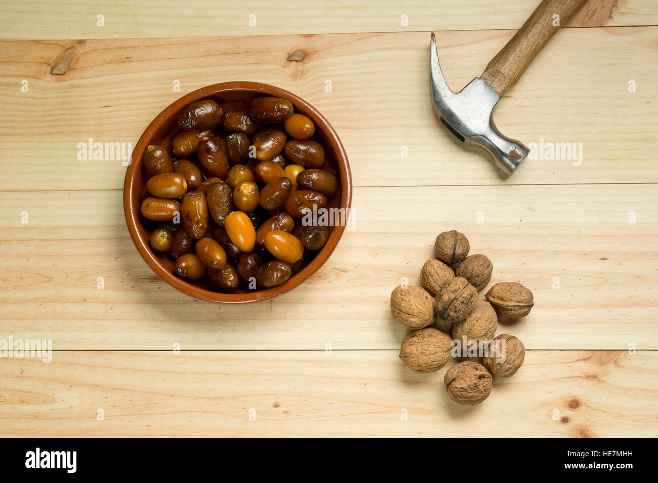 Dice and nuts on a background of pine wood. Artificial lighting with ...