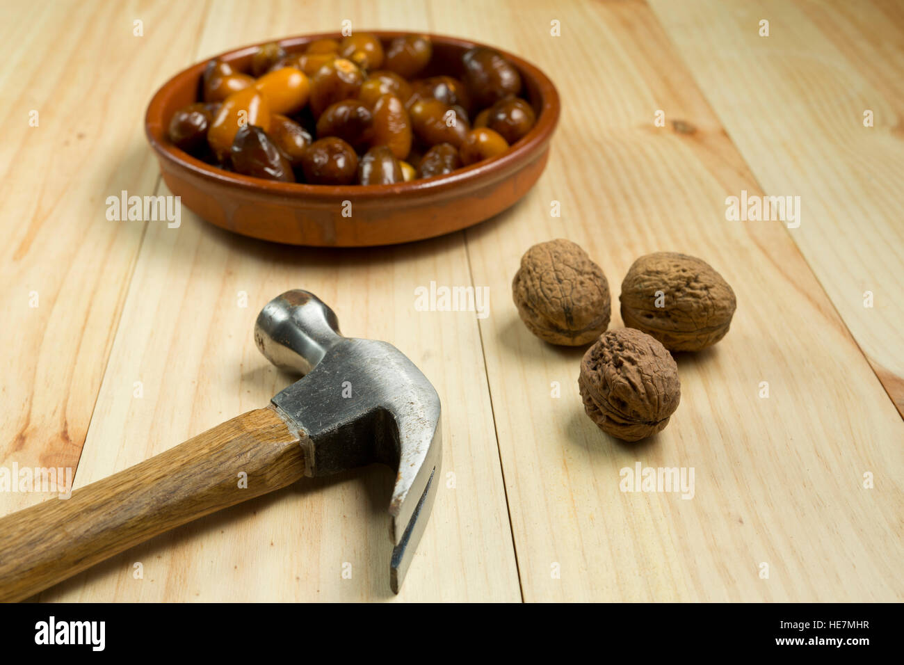 Dice and nuts on a background of pine wood. Artificial lighting with ...