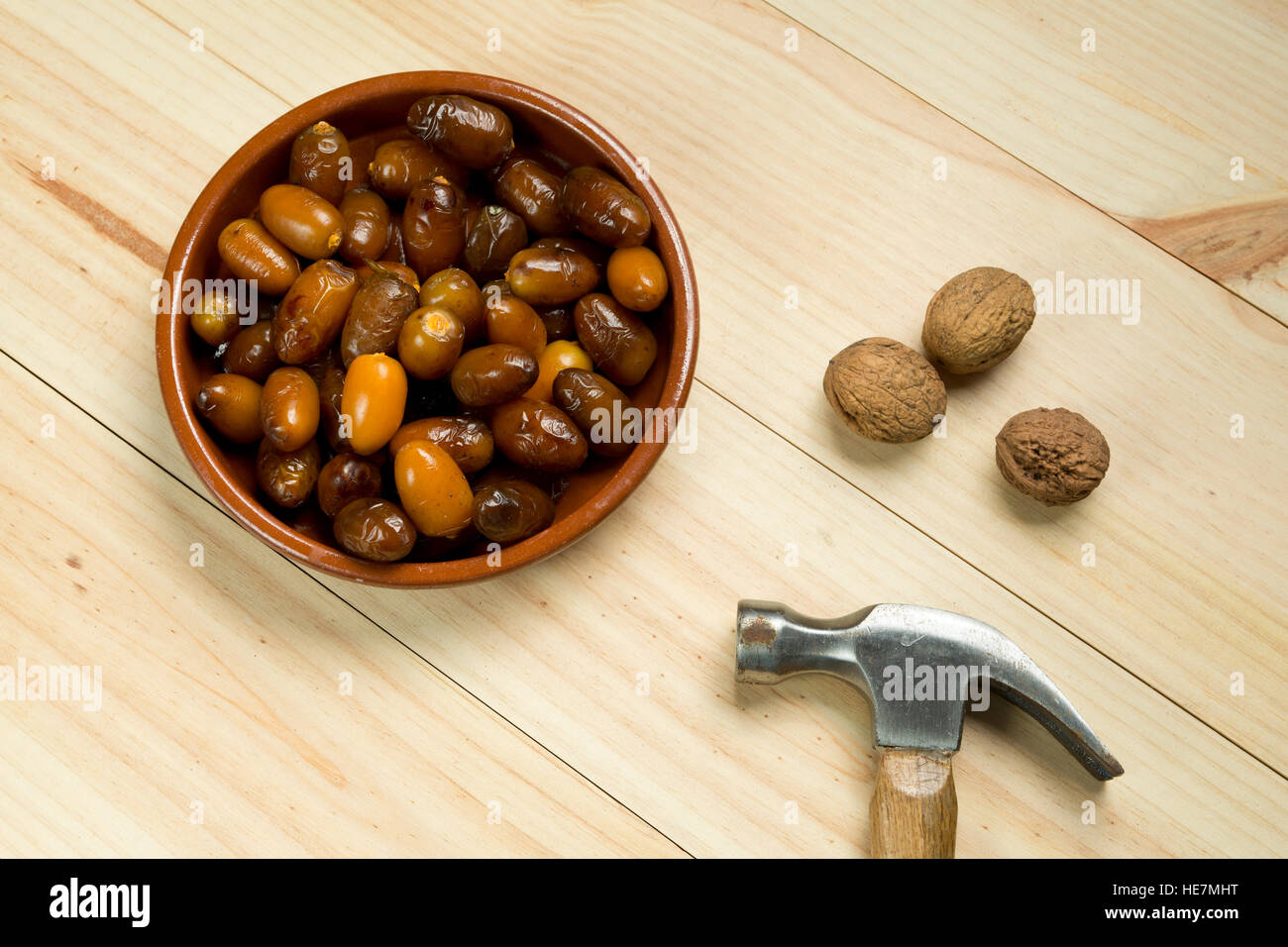Dice and nuts on a background of pine wood. Artificial lighting with ...