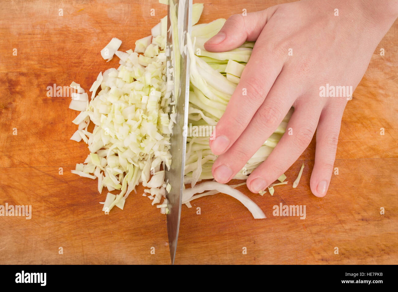 female hands slicing cabbage on wooden board Stock Photo - Alamy