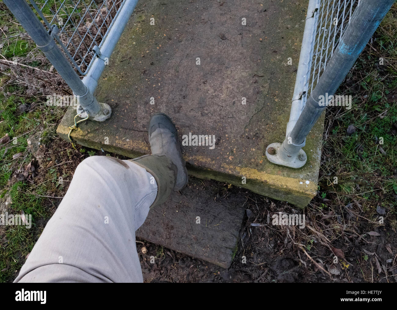Field walker about to step on a slippery concrete footbridge while ...