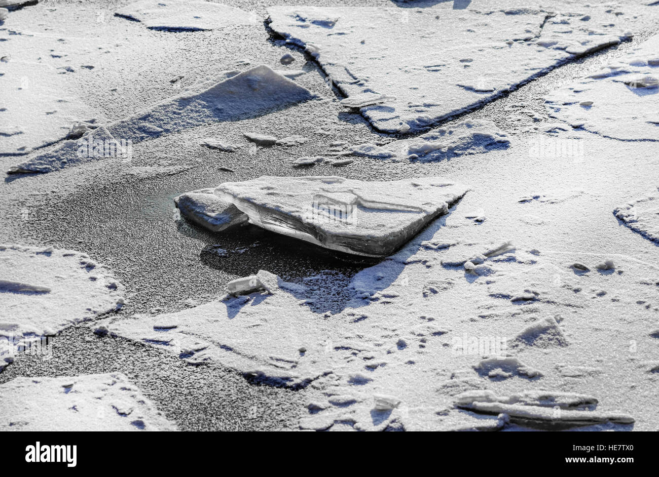 Big white ice in dark winter water Stock Photo - Alamy