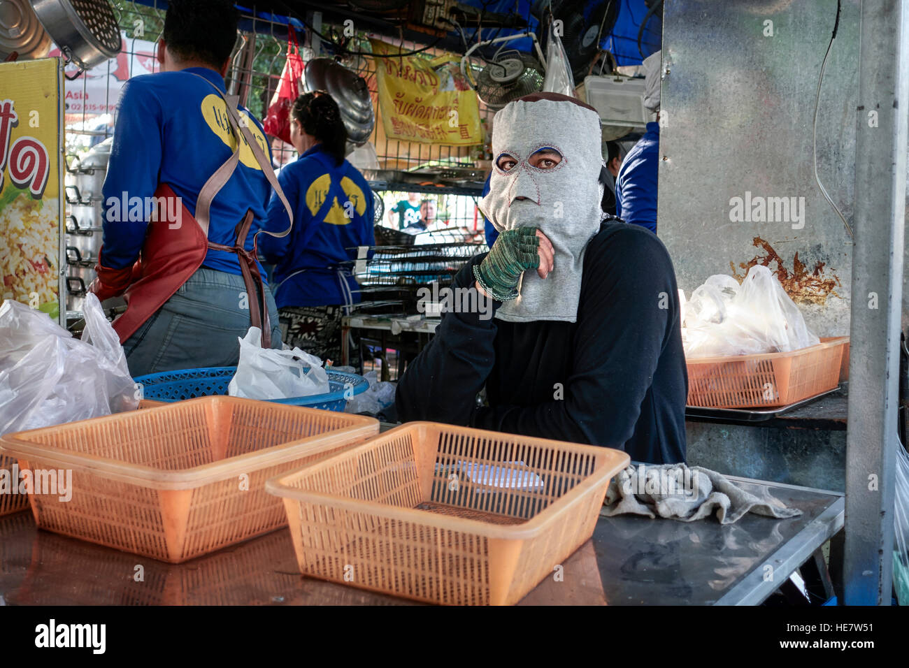 Heat protective full face mask worn by a Thai chef working at a market ...