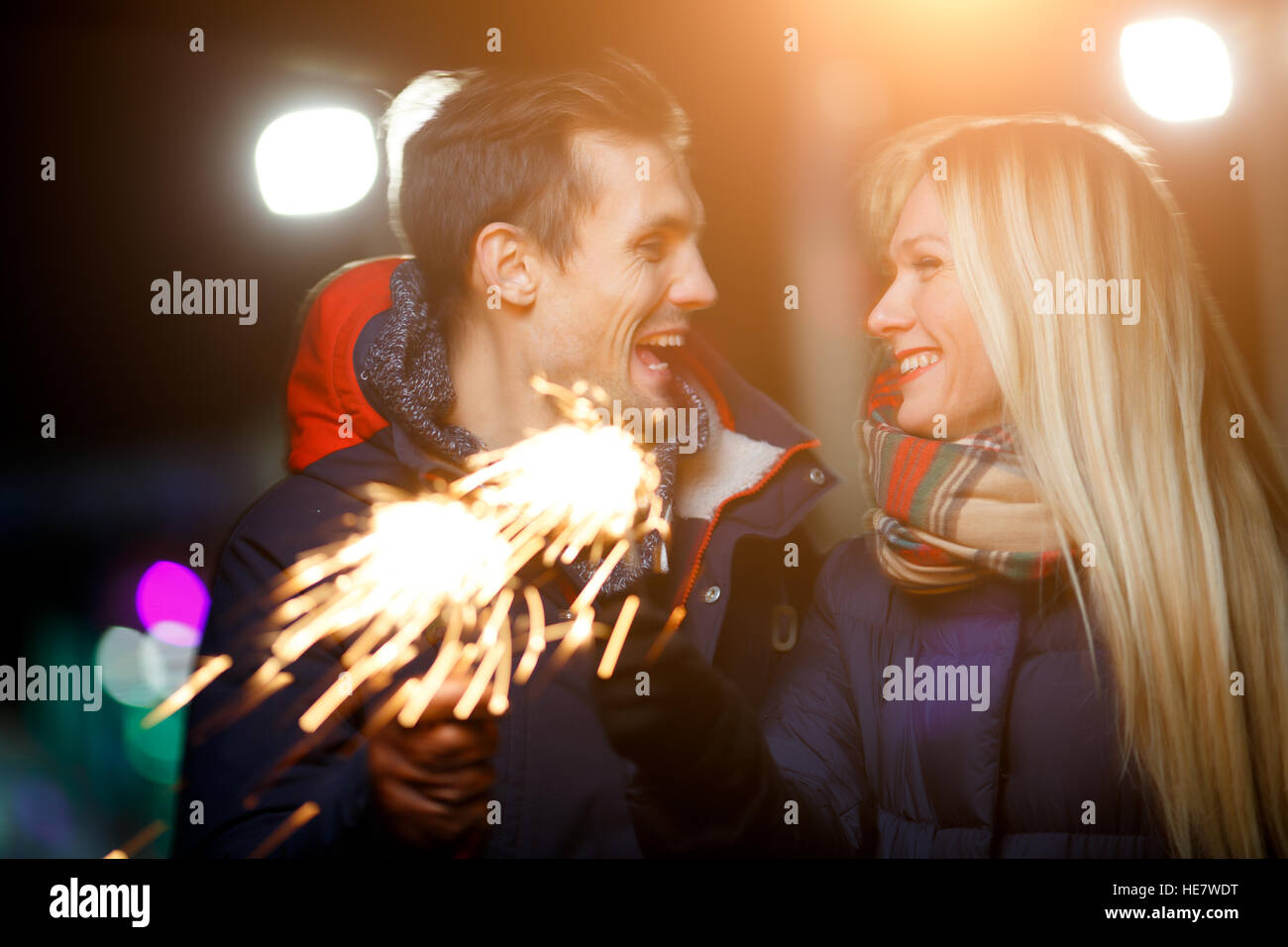 Beautiful couple with sparklers outdoors Stock Photo - Alamy