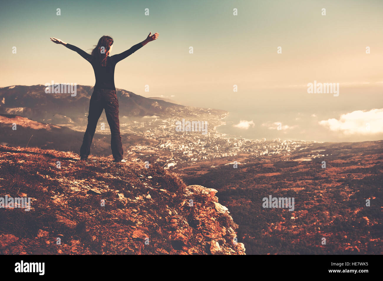 Woman on top of a mountain Stock Photo - Alamy