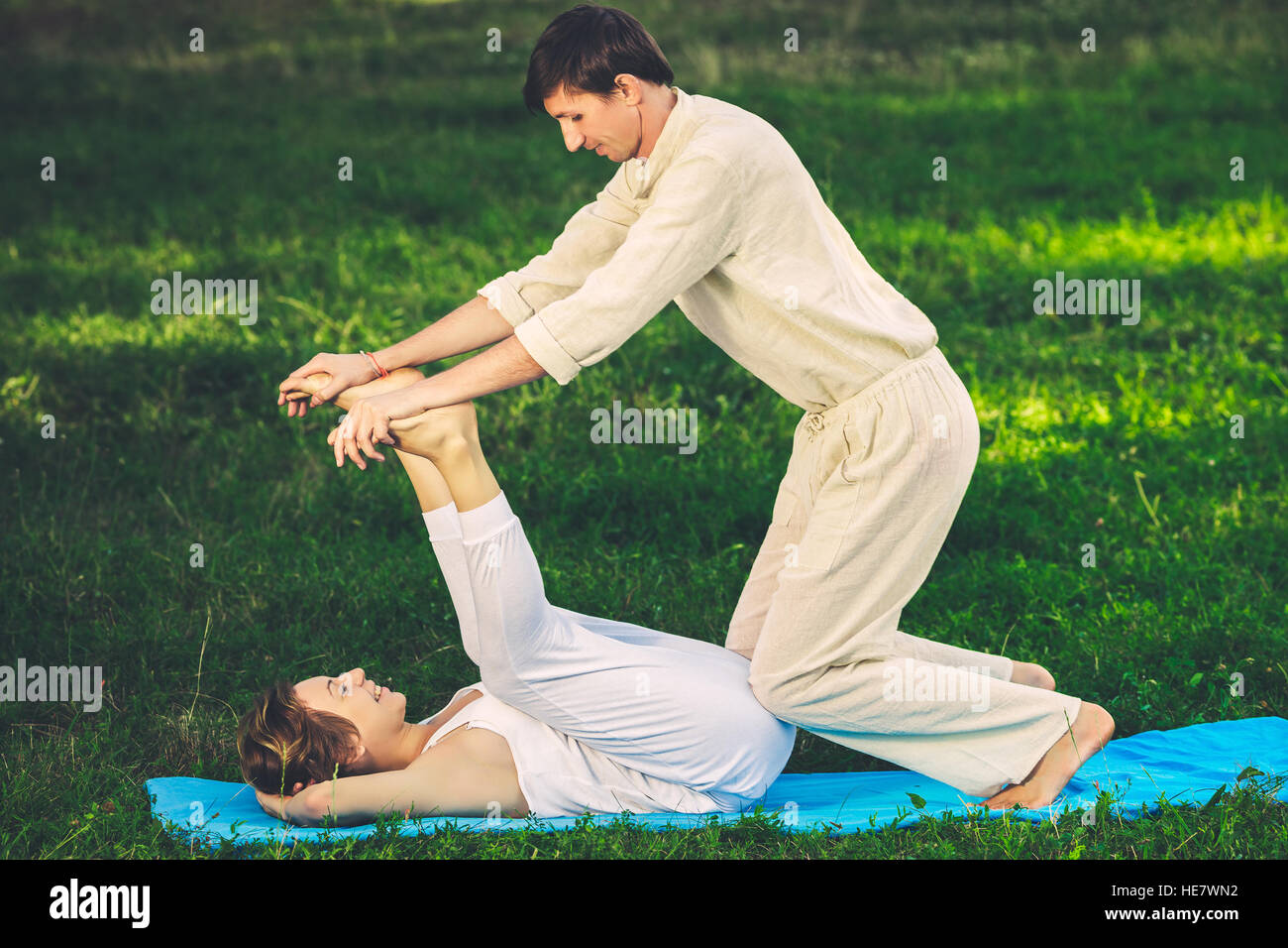 Thai massage with yoga exercises Stock Photo - Alamy