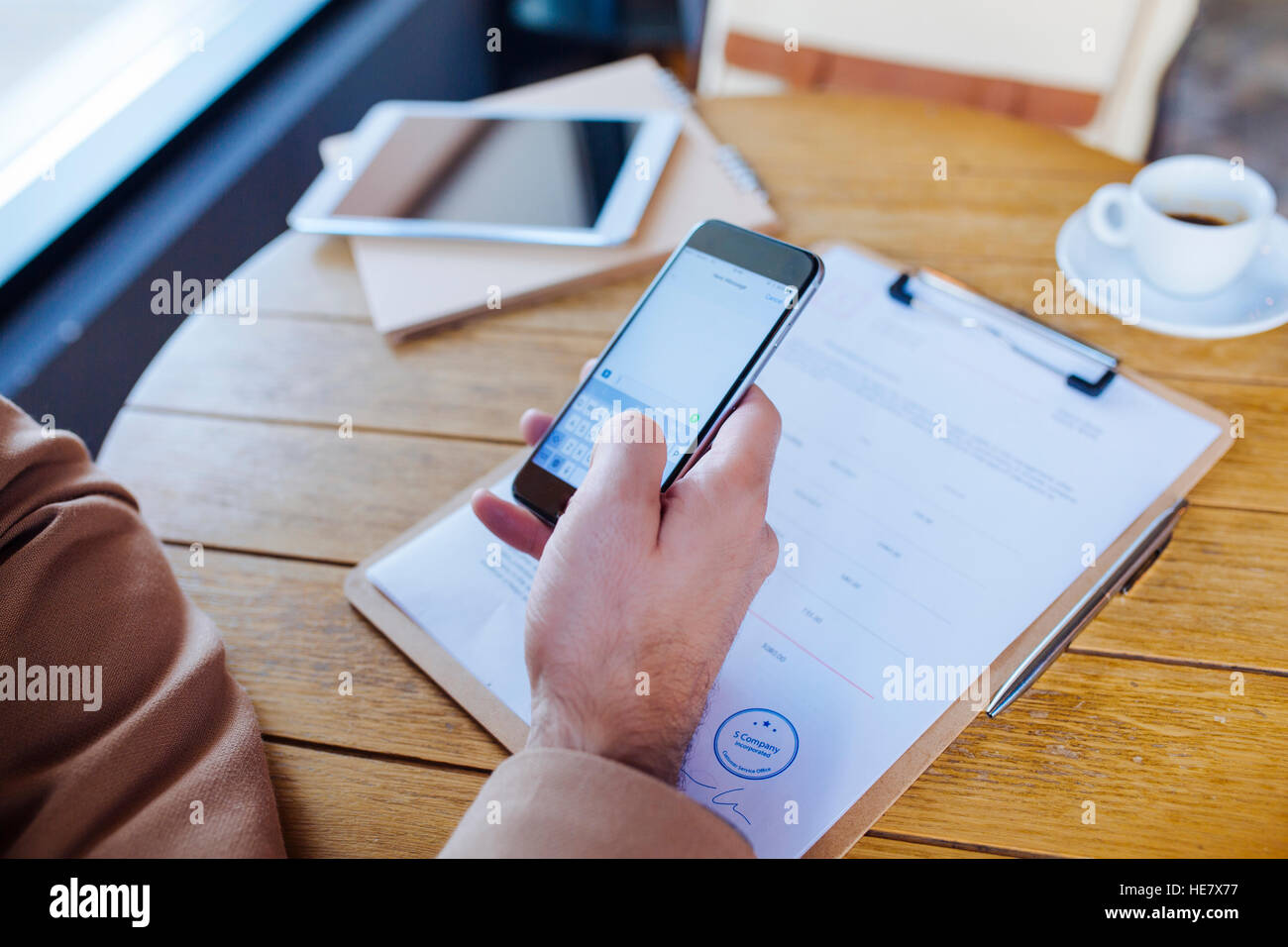 Businessman using phone in coffee shop Stock Photo - Alamy