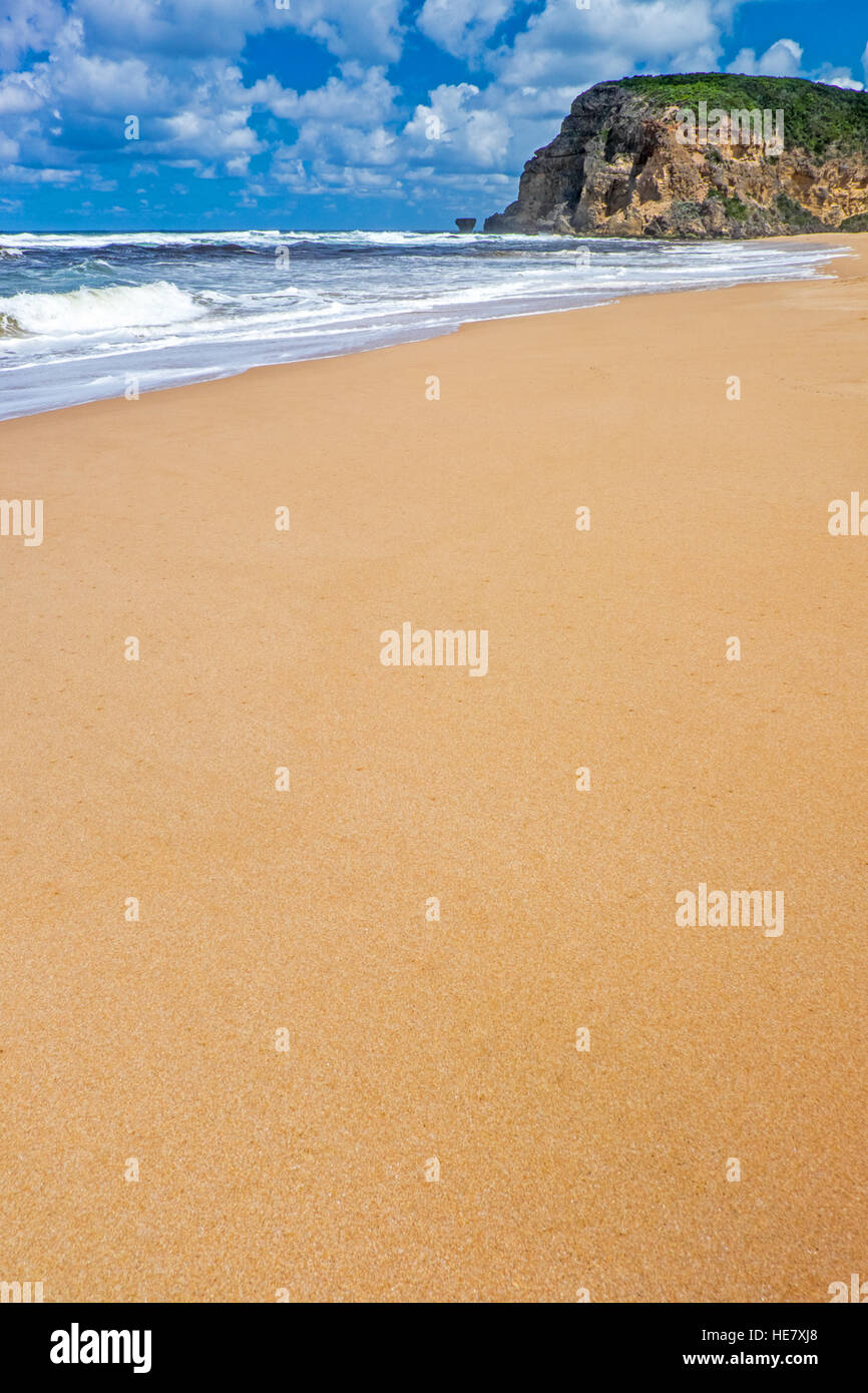 A large expanse of sand with rocks and blue skies on Australia's Great ...