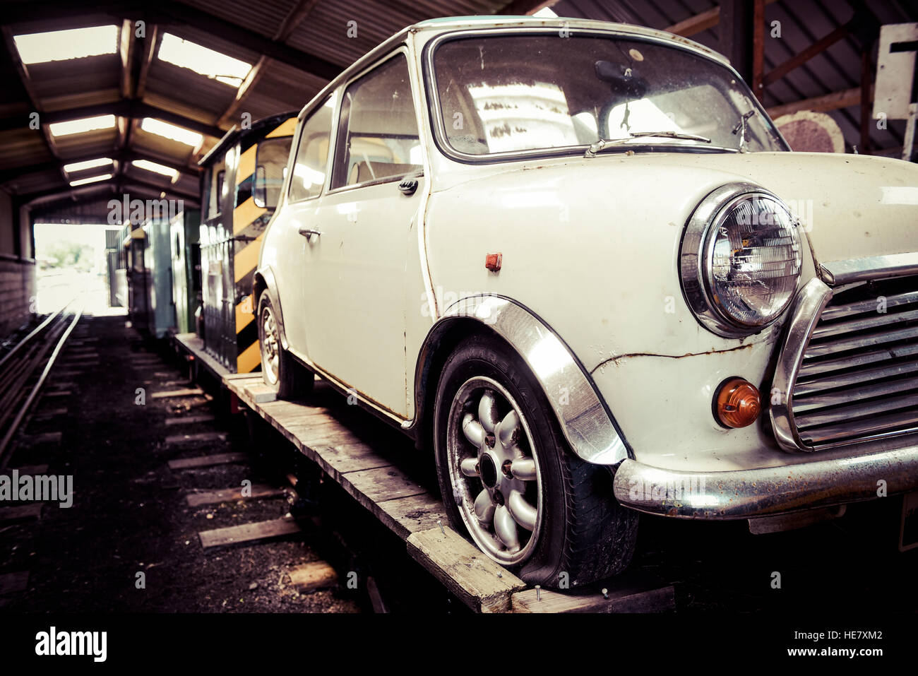 Old 1960s-70s white Mini car in train shed waiting to be transported ...