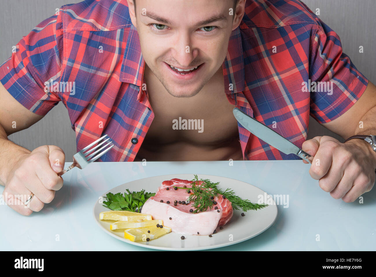 hungry man eats meat Stock Photo - Alamy