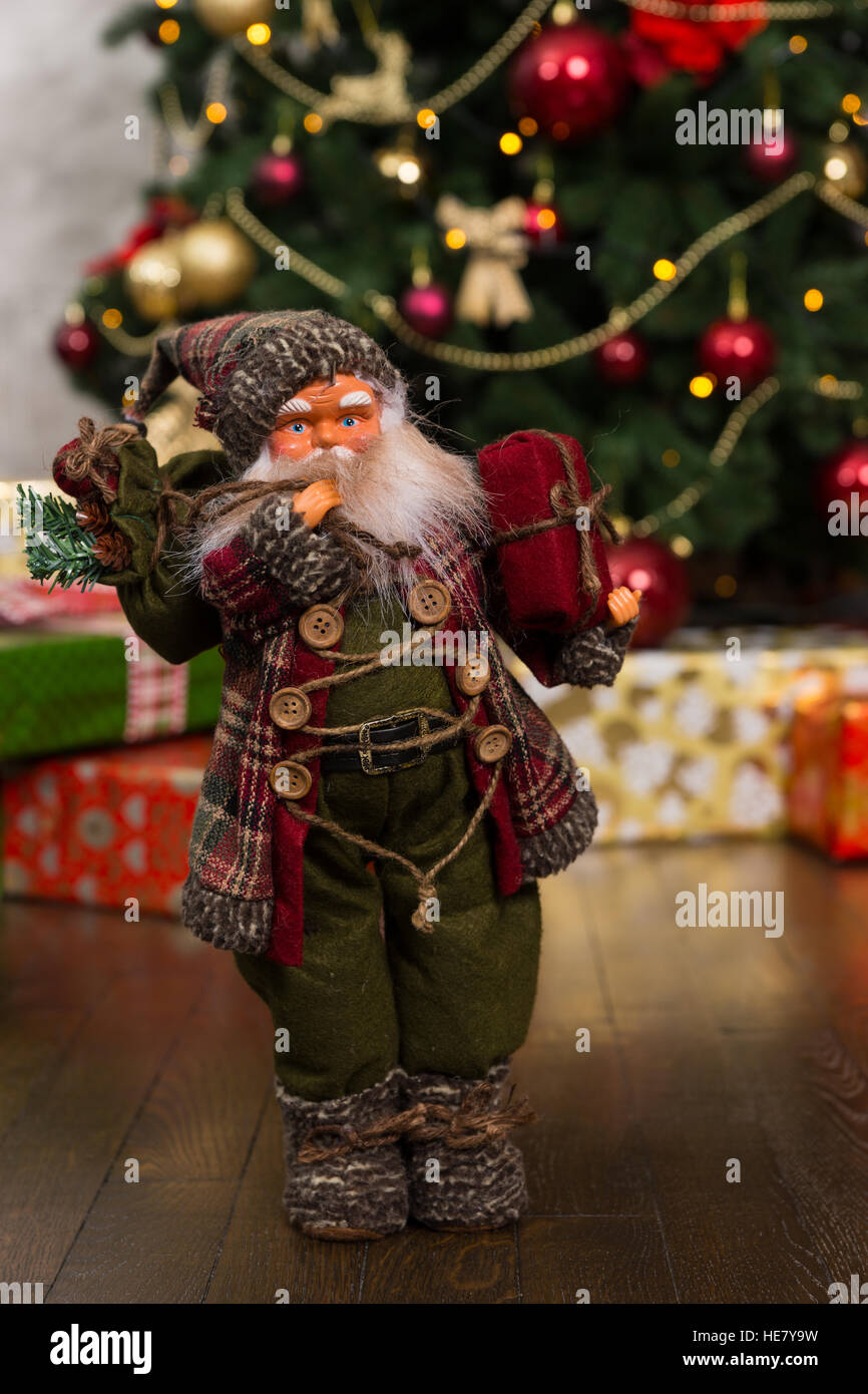 Santa Claus doll with a blush on the cheeks wearing traditional costume ...
