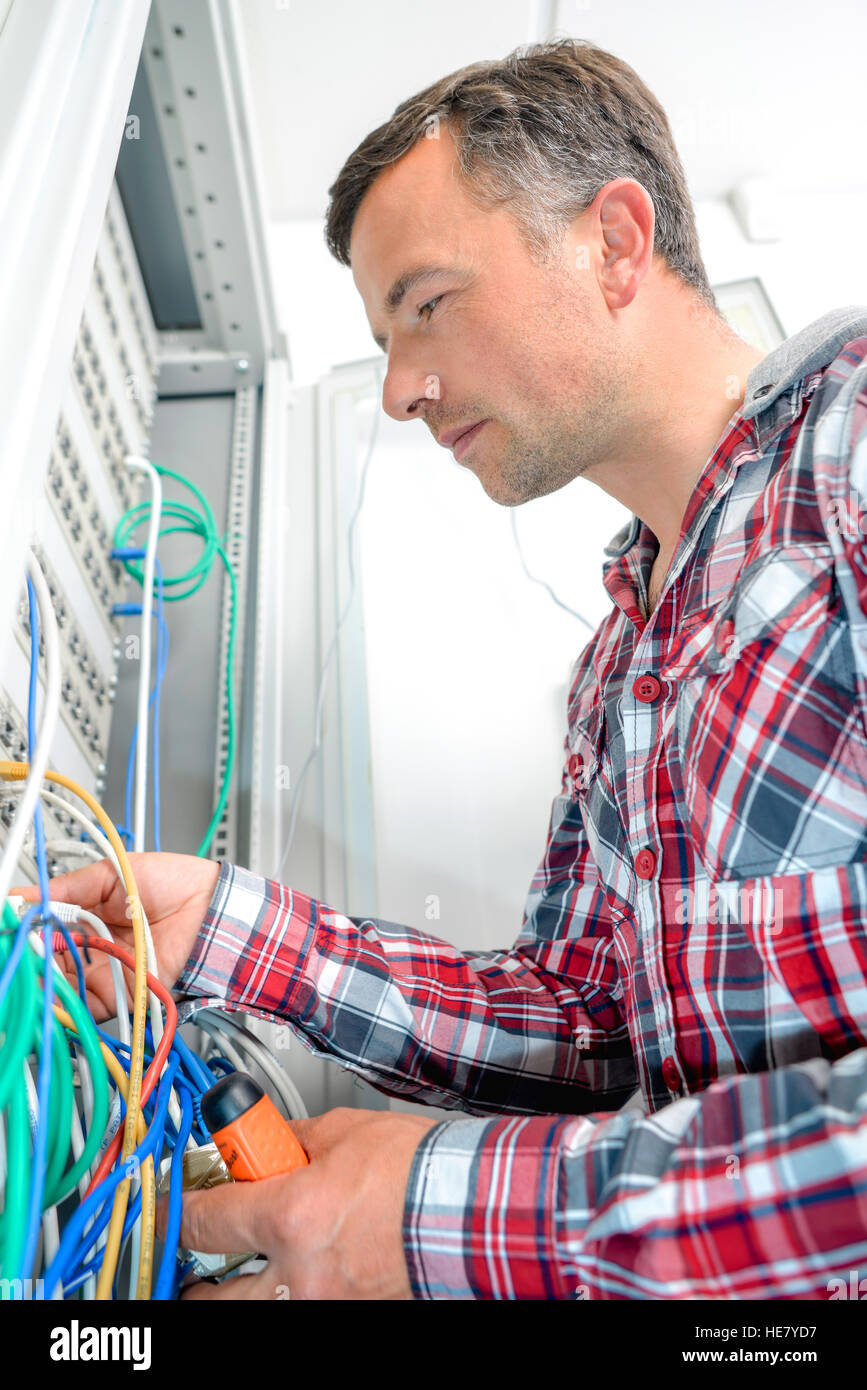Man connecting wires Stock Photo - Alamy