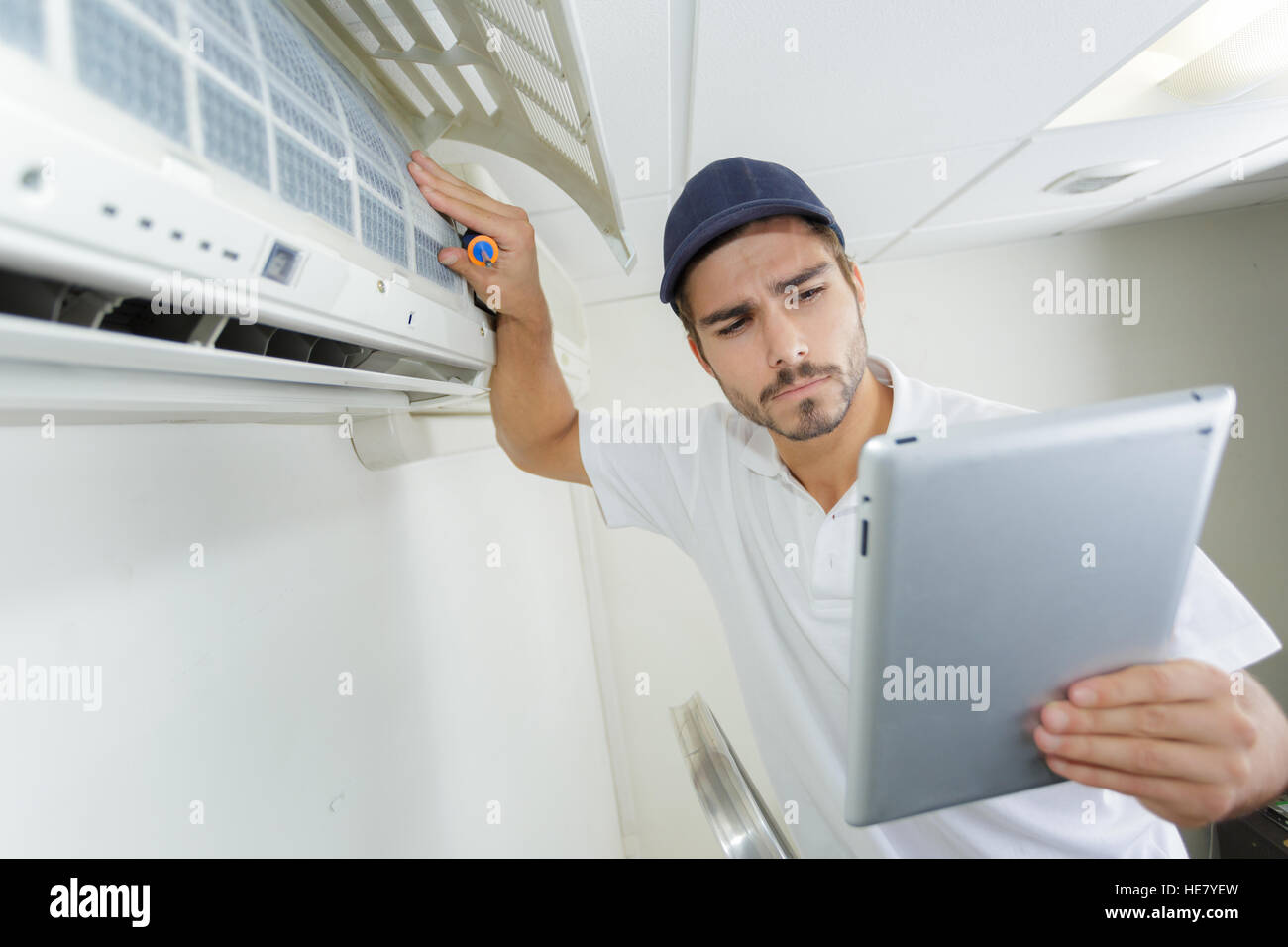 young contractor working carefully and seriously at clients office ...