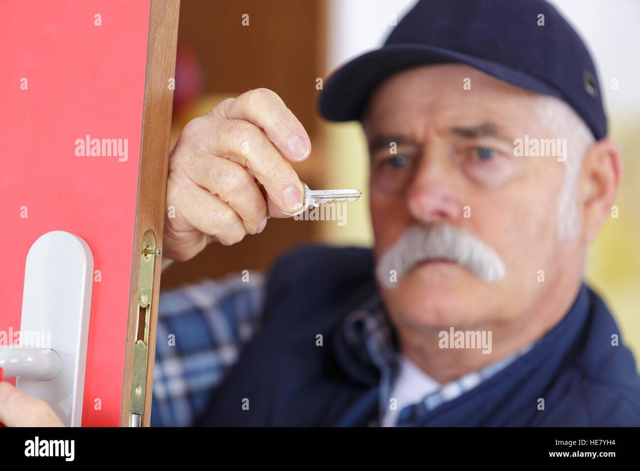 senior man repairing gate lock Stock Photo - Alamy