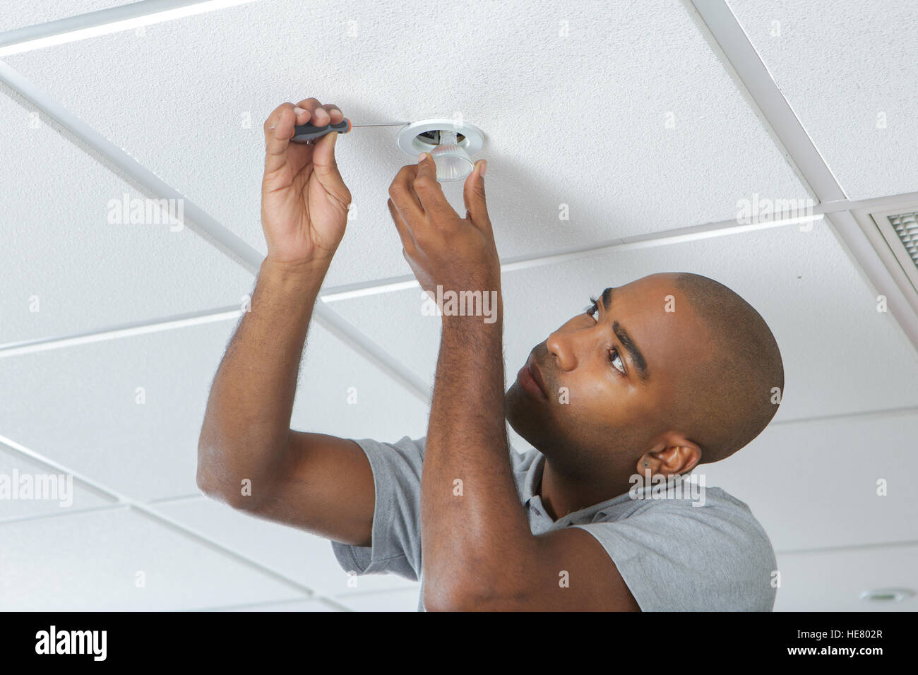 fixing a light fixture Stock Photo - Alamy