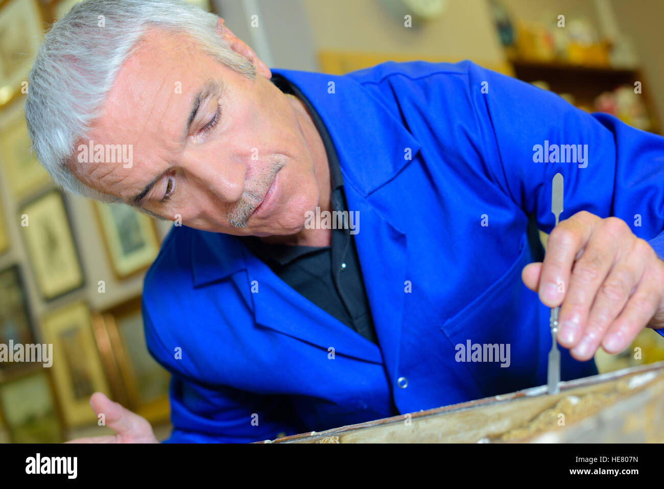 Man doing precision restoration work Stock Photo - Alamy