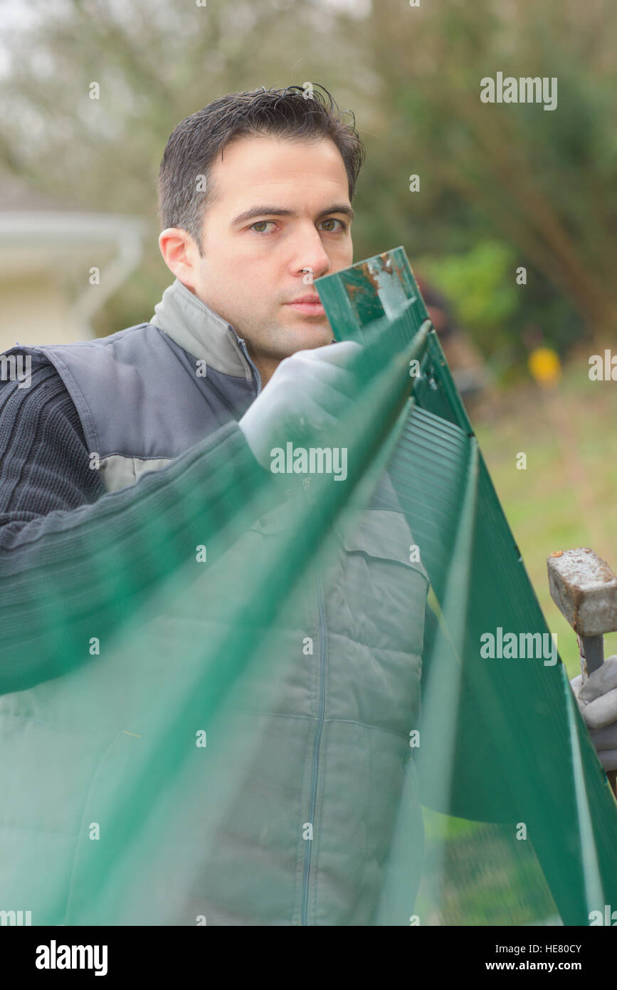 Checking a fence is straight Stock Photo - Alamy