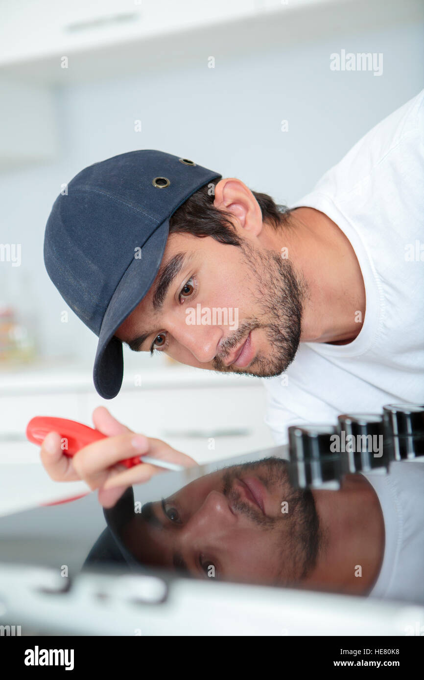 technician fixing a kitchen appliance Stock Photo - Alamy