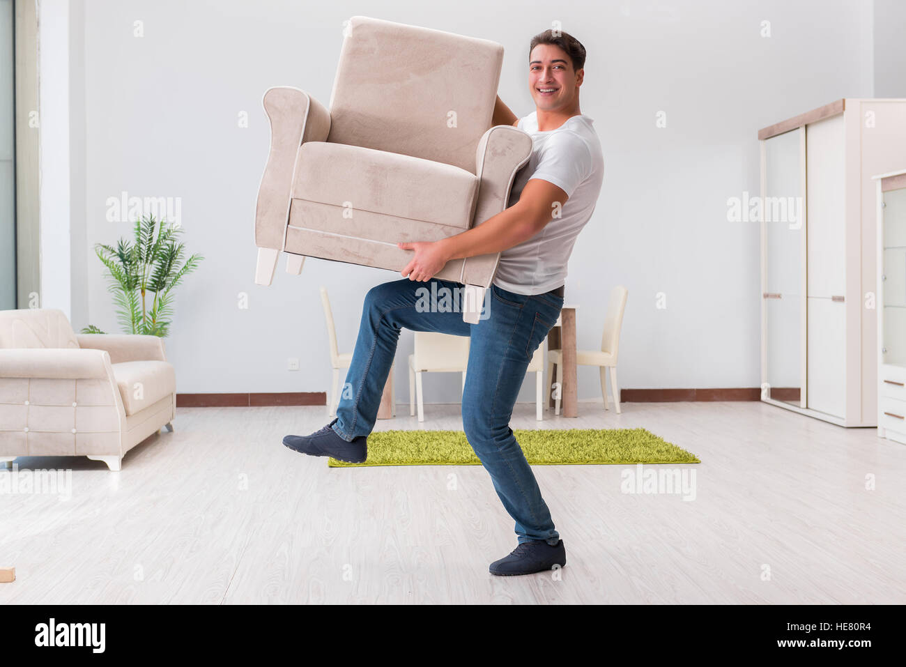 Man moving furniture at home Stock Photo - Alamy