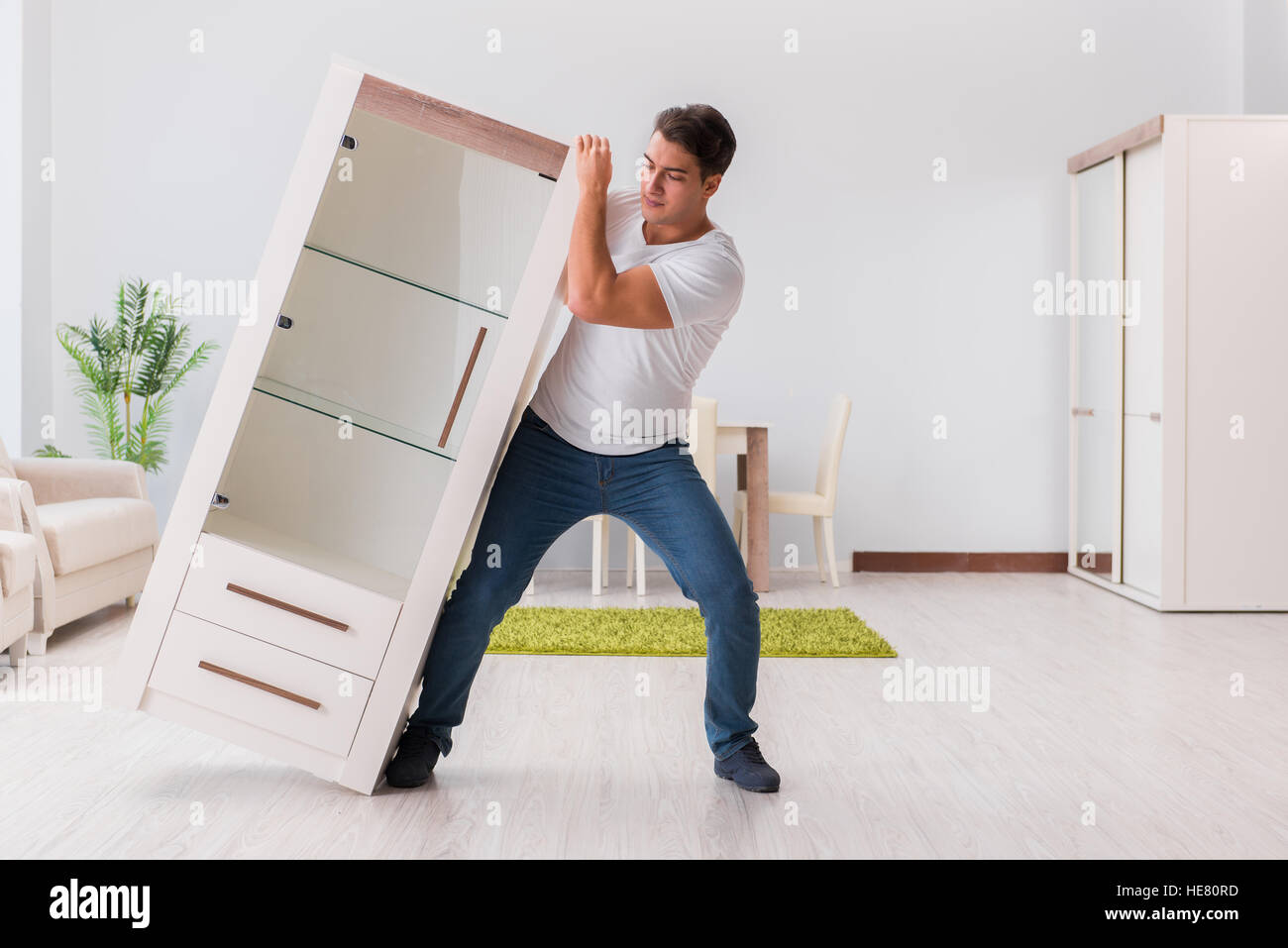 Man moving furniture at home Stock Photo - Alamy