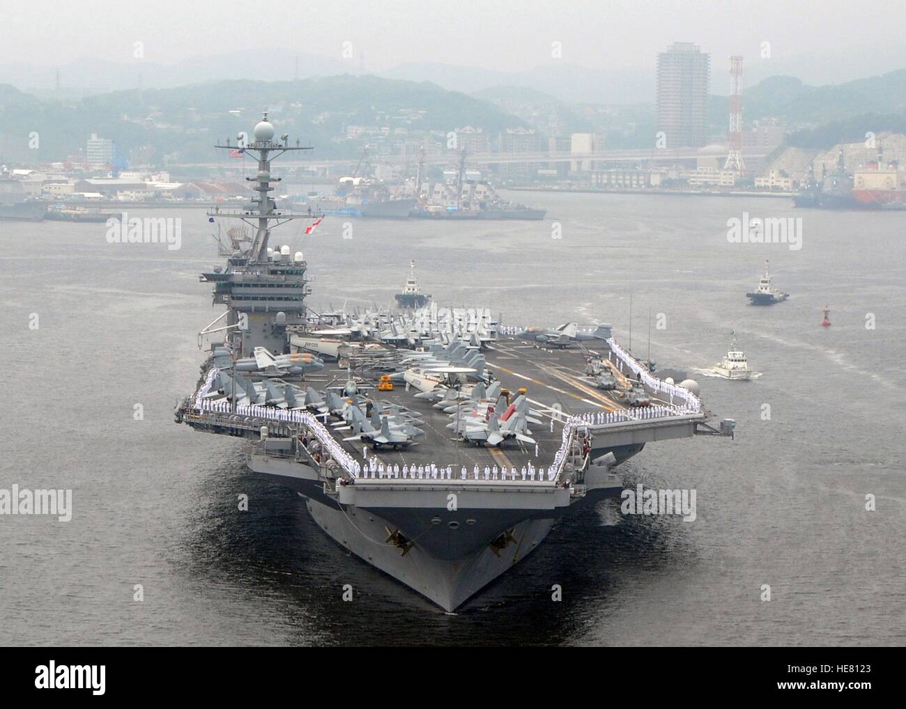U.S. sailors man the rails aboard the USN Nimitz-class aircraft carrier ...